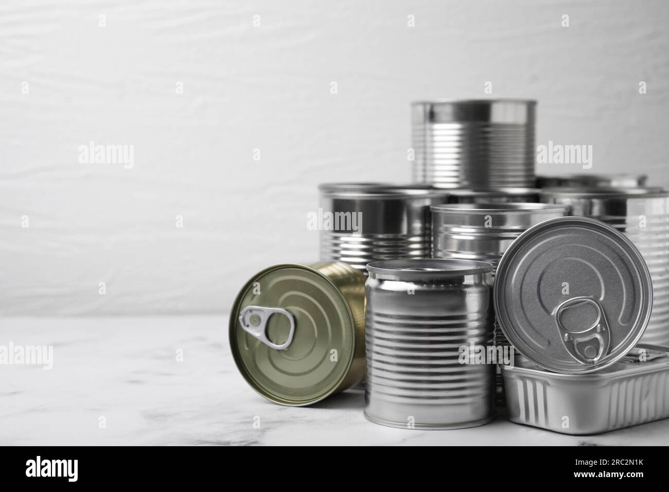 Many closed tin cans on white marble table. Space for text Stock Photo ...