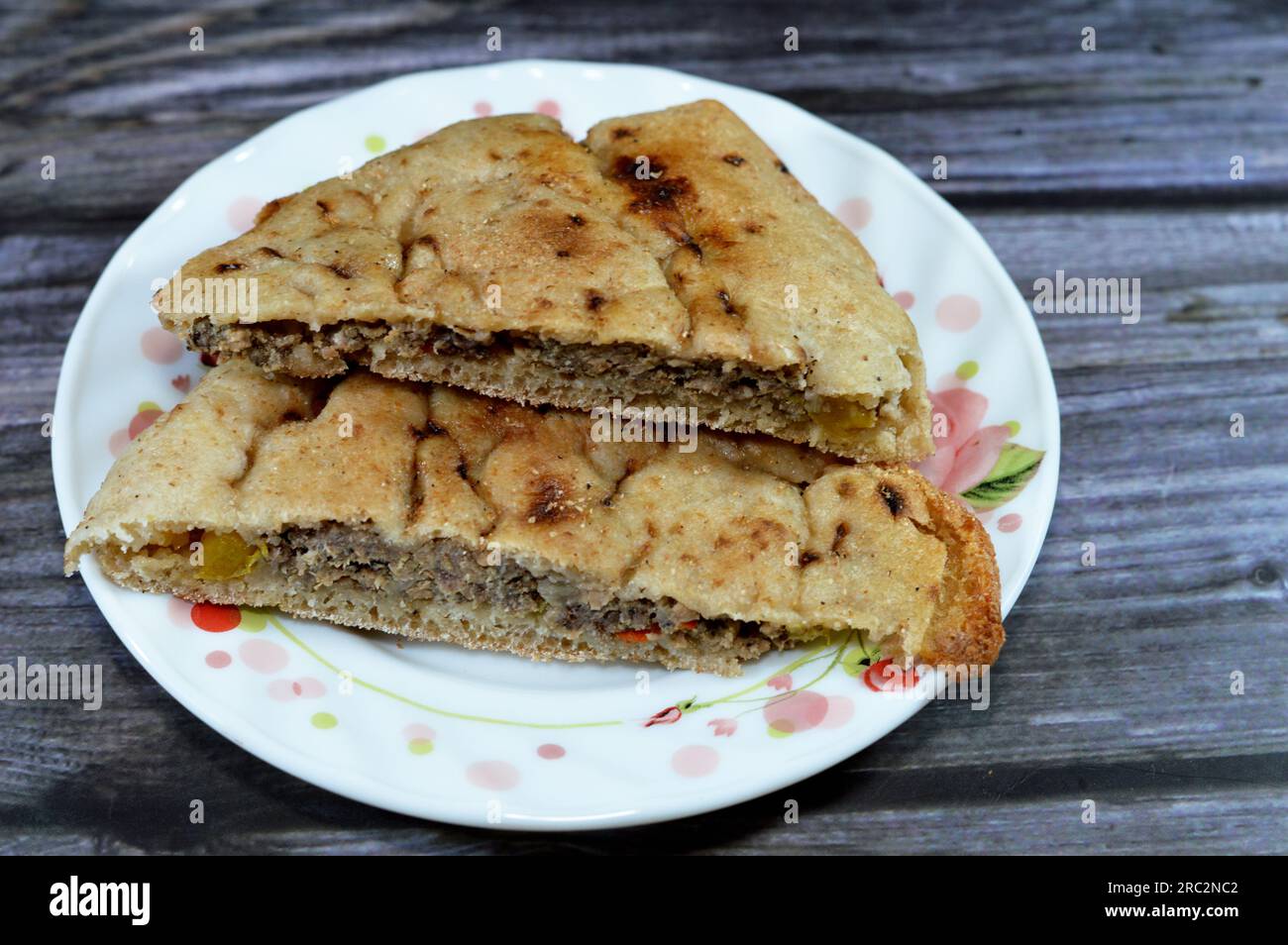 Traditional Egyptian dish Hawawshi, pita stuffed with minced meat and ...