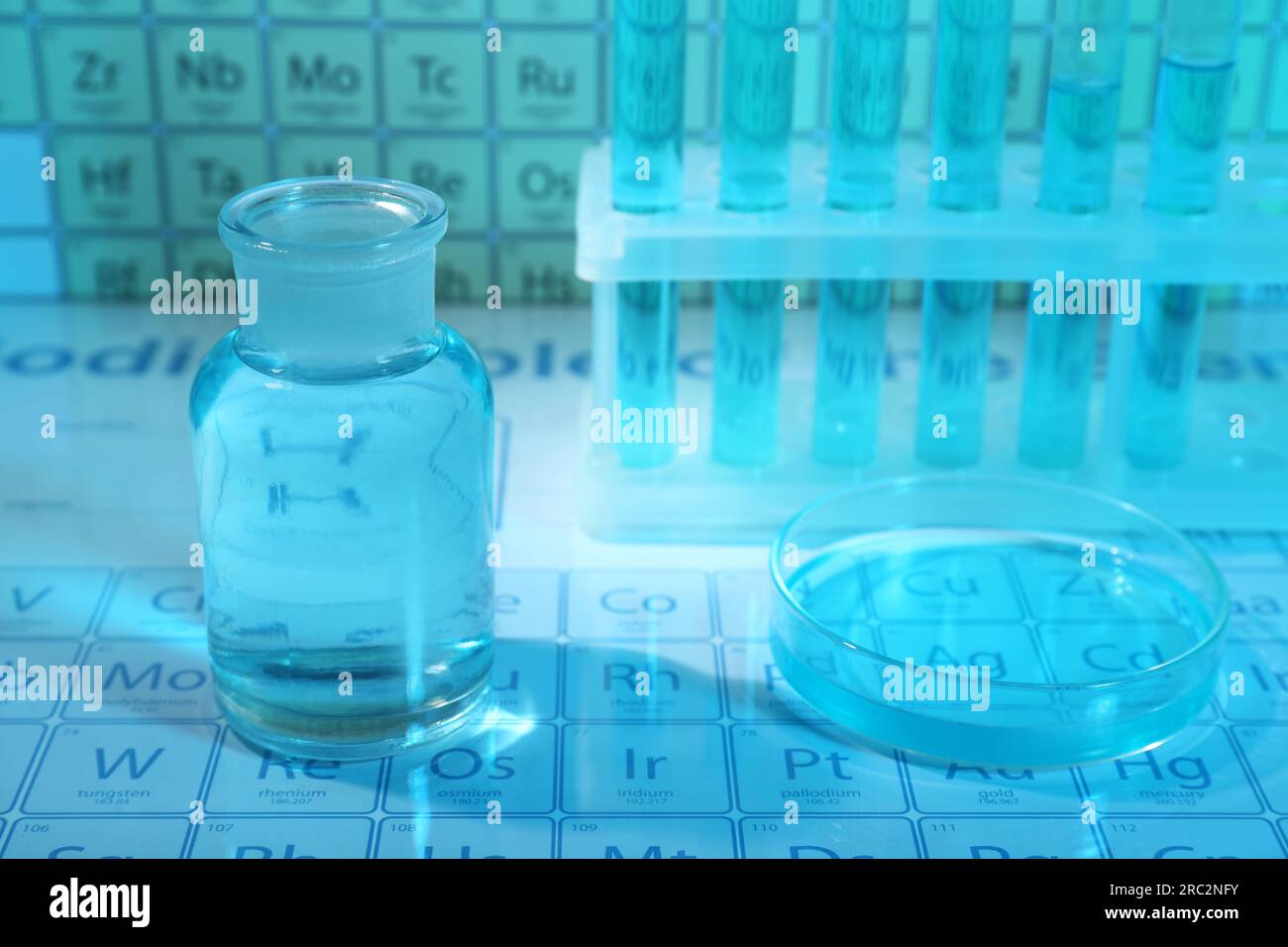 Laboratory glassware and petri dish on periodic table of elements ...
