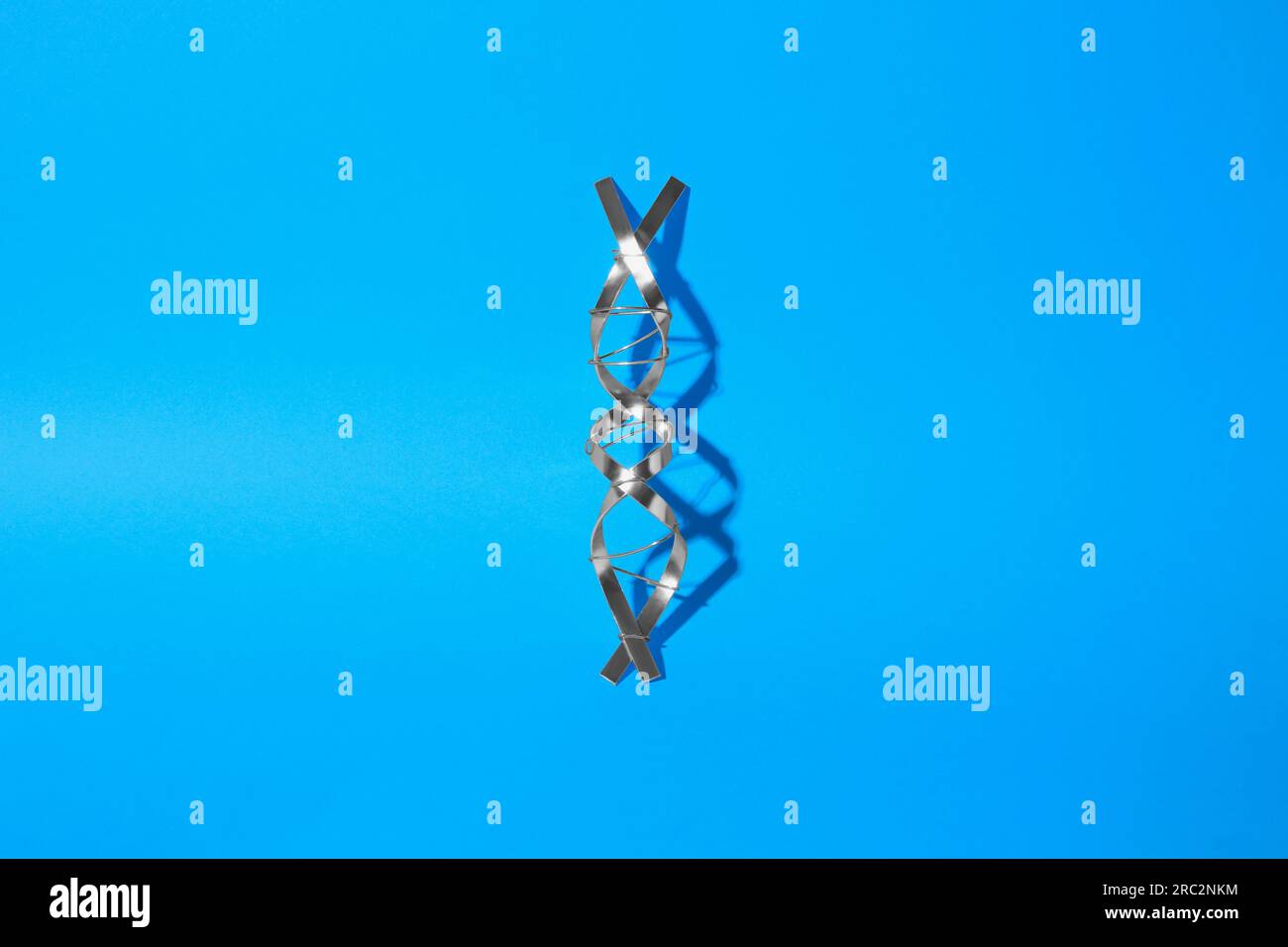 DNA molecular chain model made of metal on blue background, top view ...