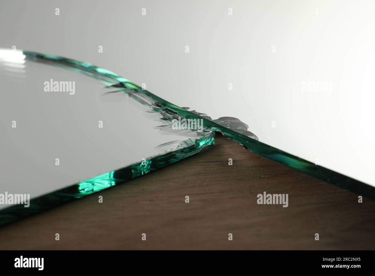 Shard of broken mirror on wooden backing board, closeup Stock Photo - Alamy