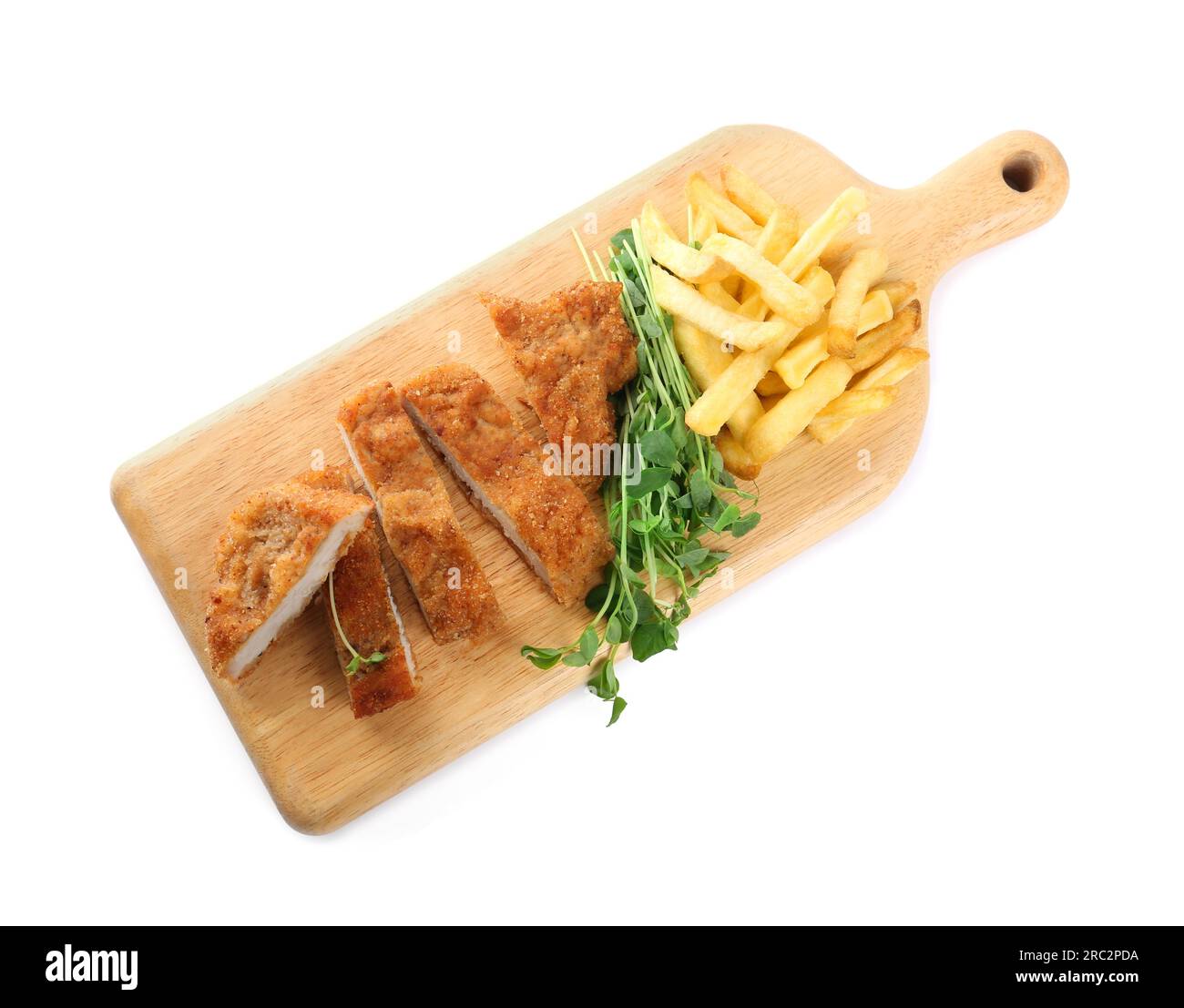 Delicious cut schnitzel with french fries and microgreens on white ...