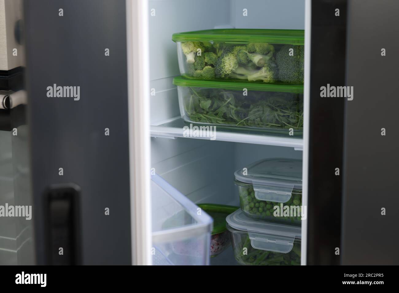 Glass containers with different fresh products in fridge. Food storage ...