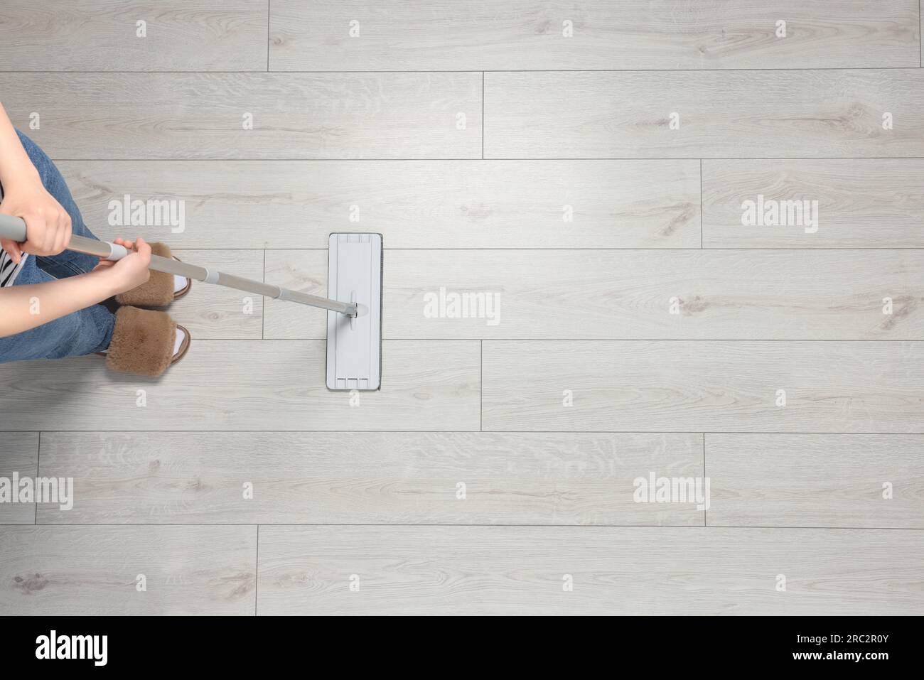 Woman mopping wooden floor hi-res stock photography and images - Alamy