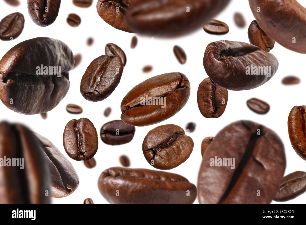 Roasted coffee beans falling o white background Stock Photo - Alamy