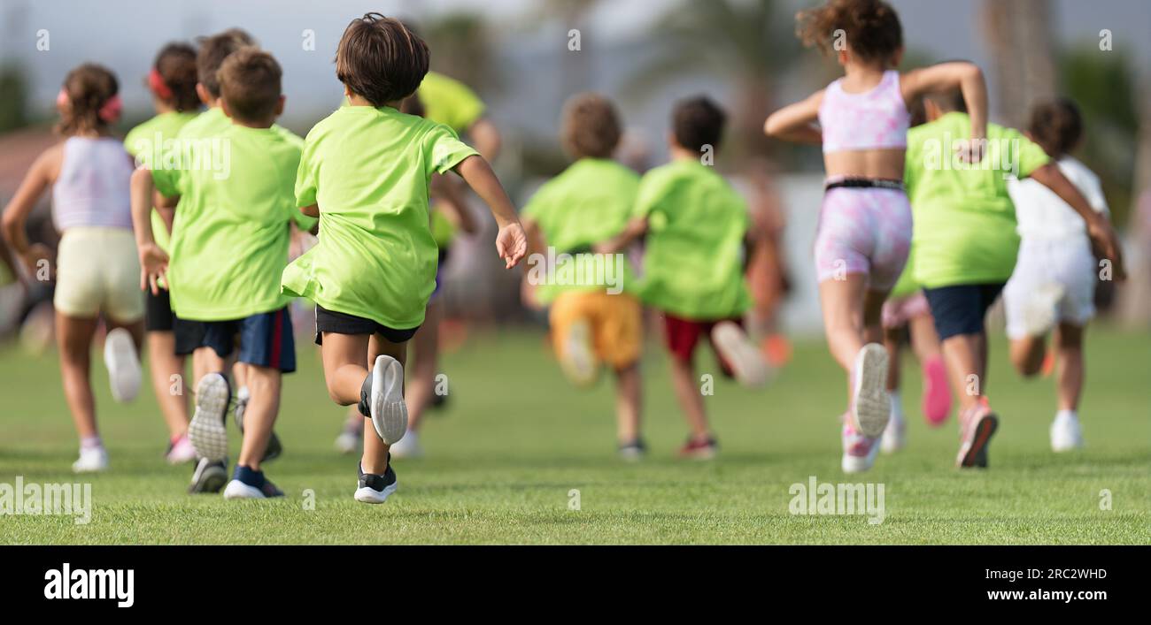 Running children, young athletes run in a kids run race, running on ...