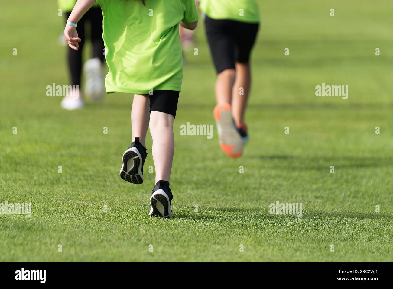 Running children, young athletes run in a kids run race, running on ...