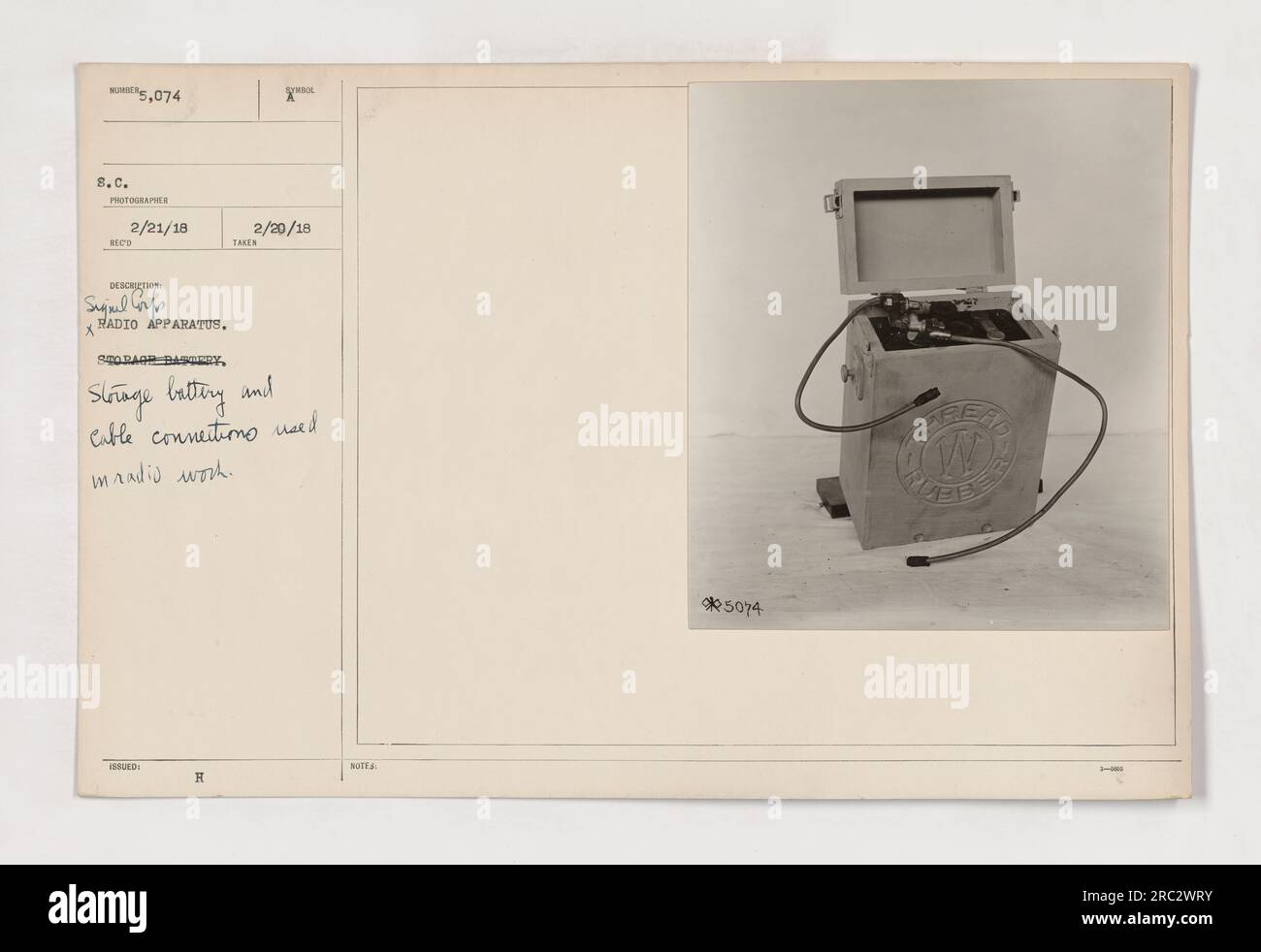 A photograph showing a signal corpsman working with a radio apparatus ...