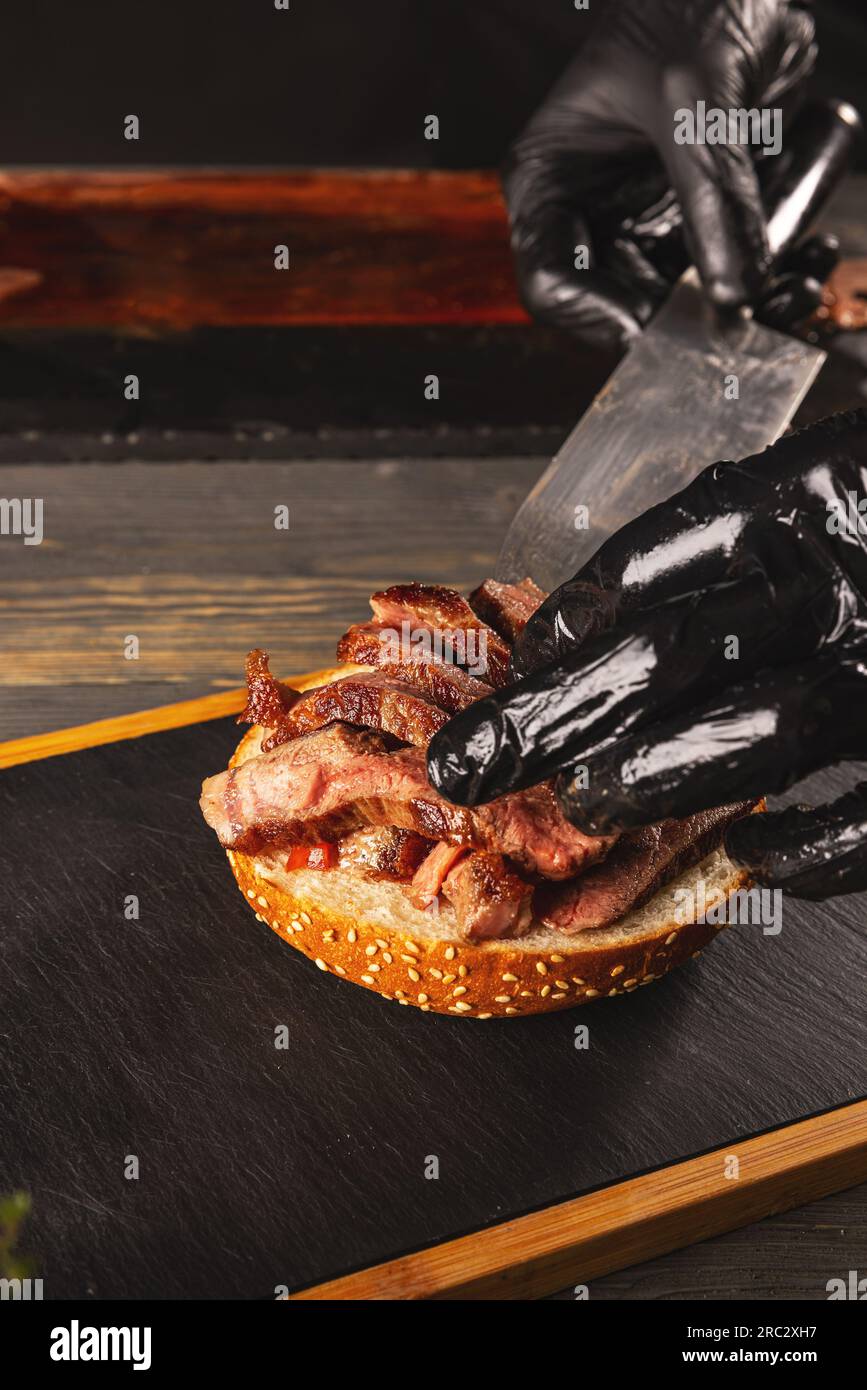 Preparation of burger. Street food. Professional chef is preparing ...