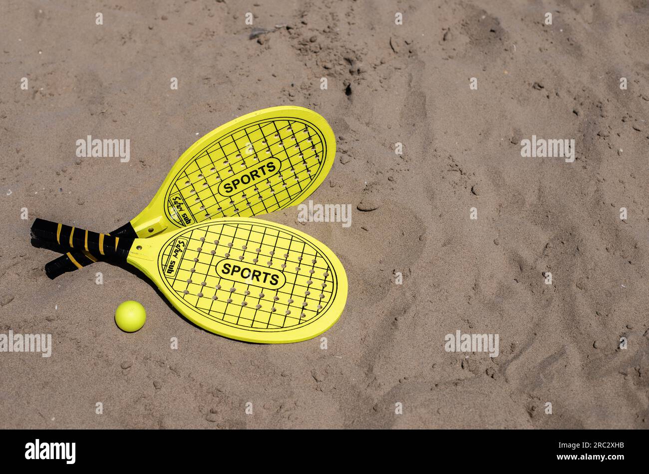 Beach tennis racket and ball on tne beach Stock Photo - Alamy