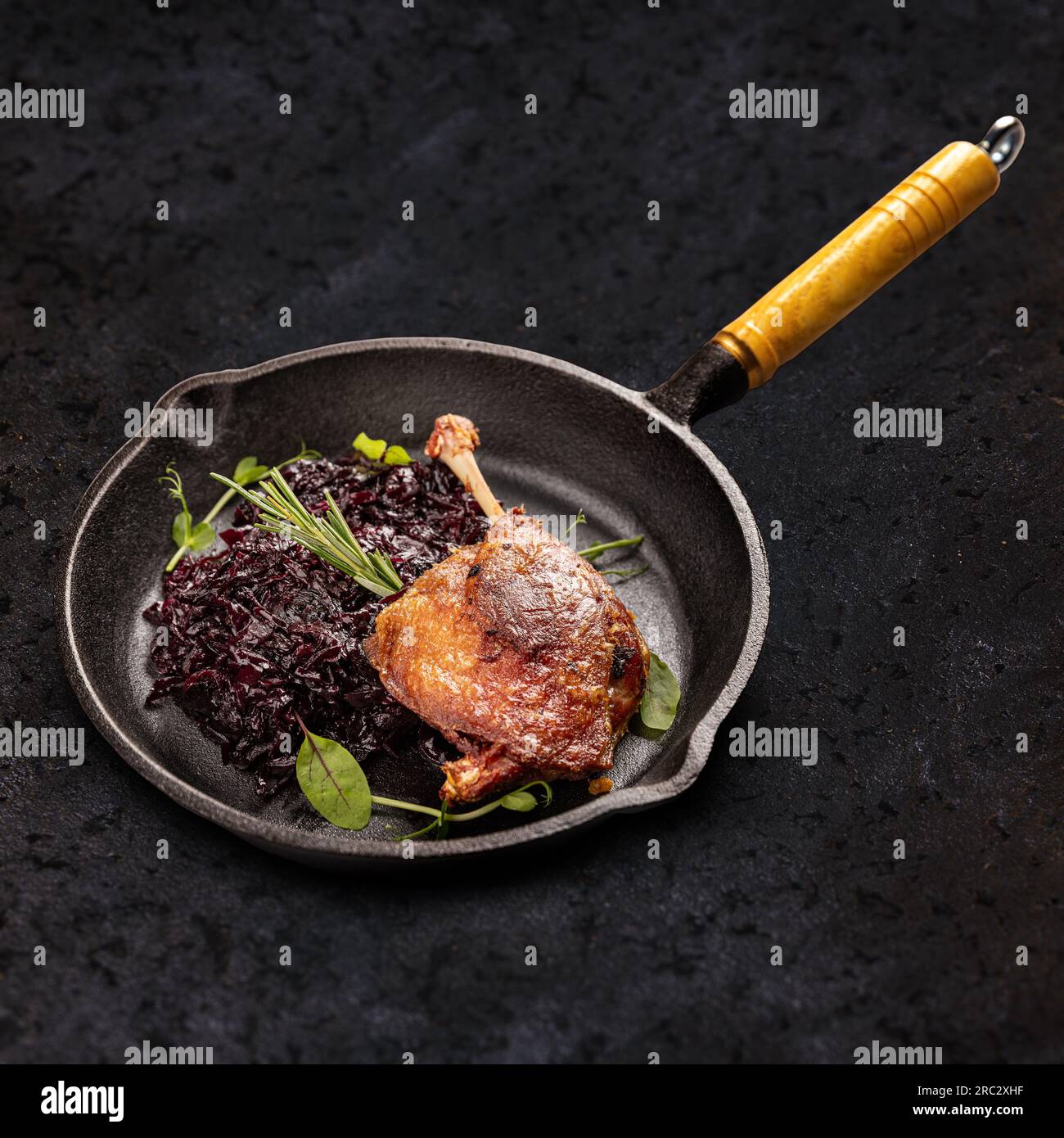 Portion of roast duck leg served with red cabbage Stock Photo - Alamy