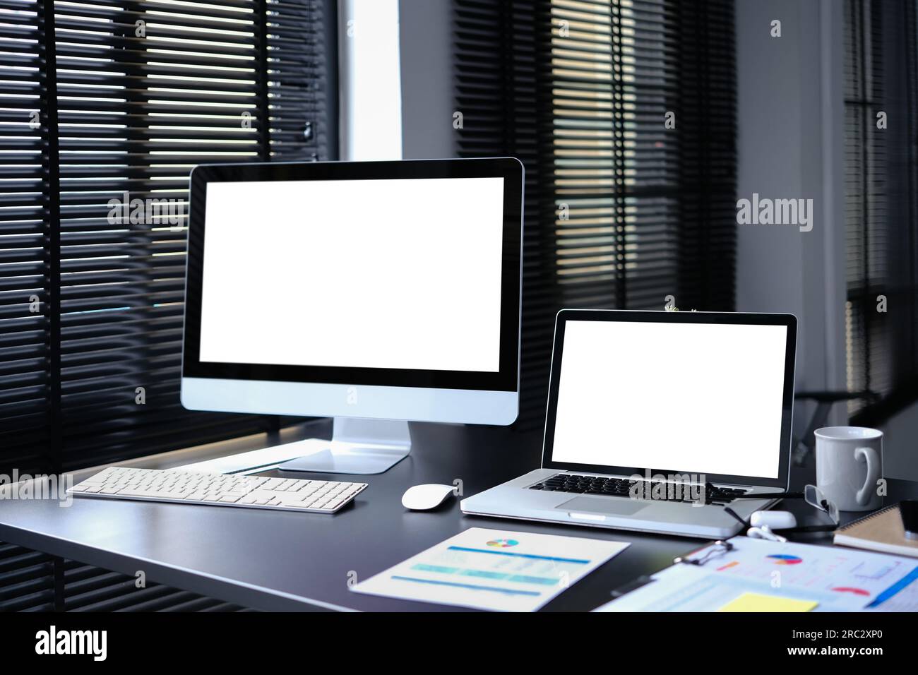 Modern workplace with bank screen of desktop computer and laptop on ...