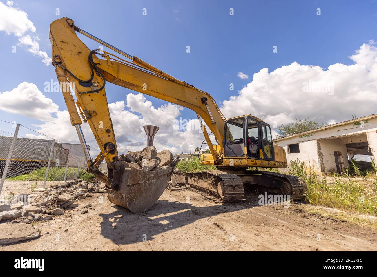 Crawler excavator on demolition site. Front view of a big crawler ...