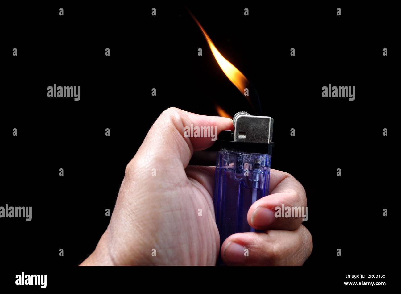 Turn on a gasoline lighter on a black background Stock Photo - Alamy