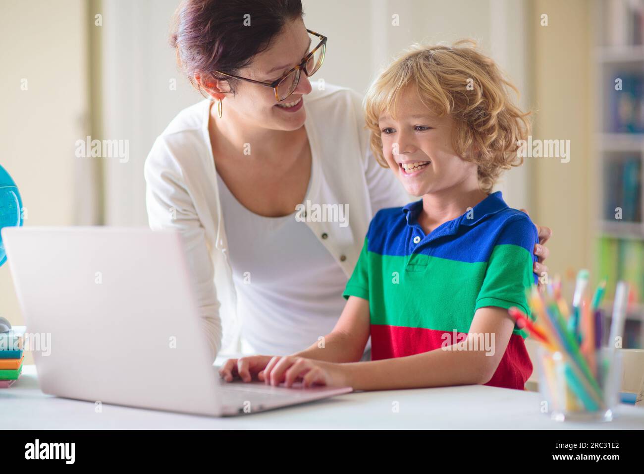 Child doing homework on computer. Online class. Homeschooling and ...