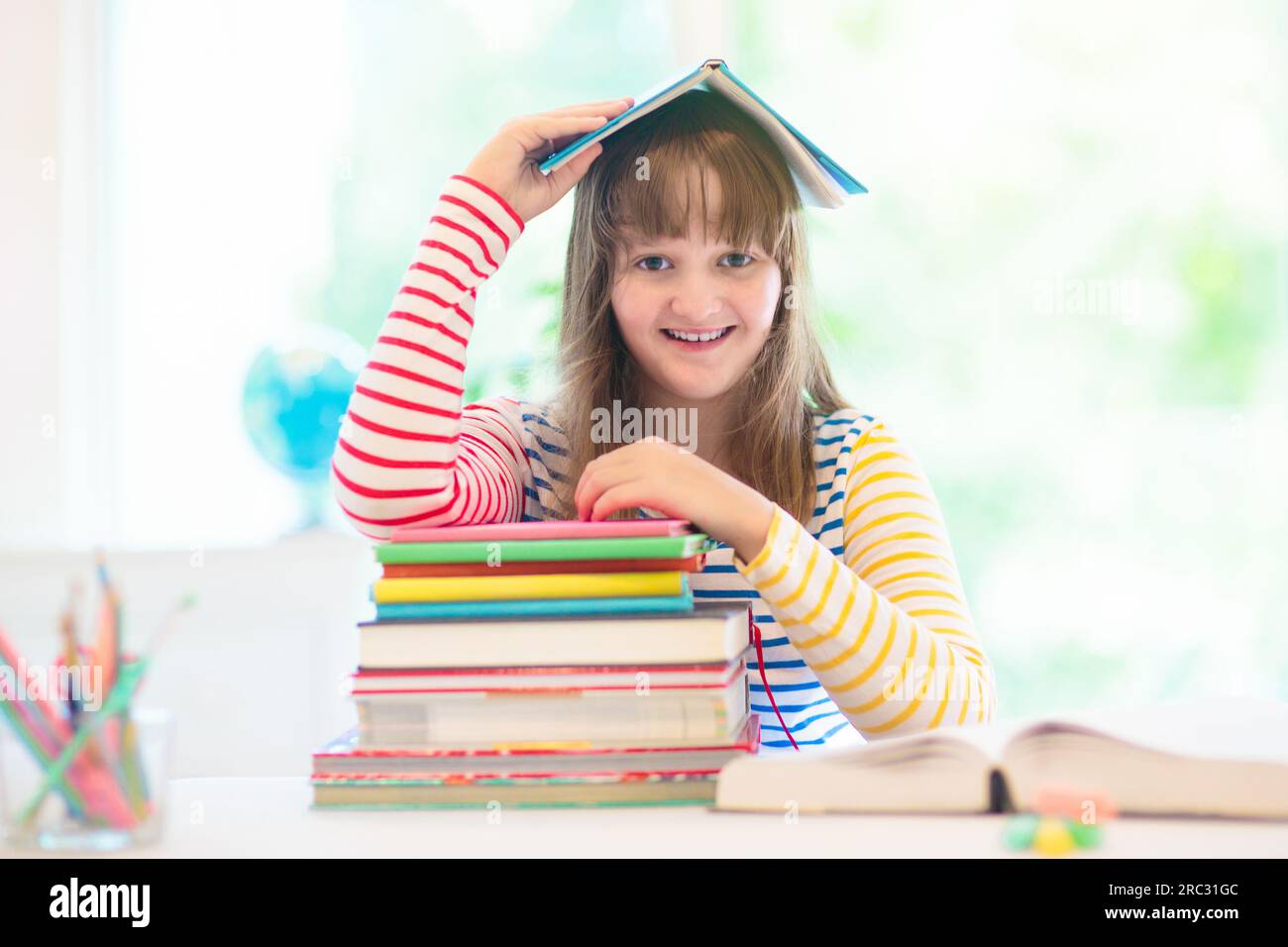 Child doing homework at home. Little kid with colorful books reading ...