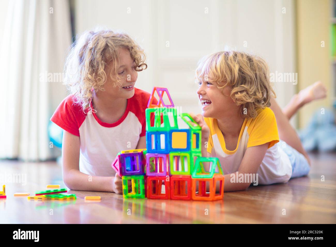 Child playing with magnetic building blocks. Little boy building tower ...