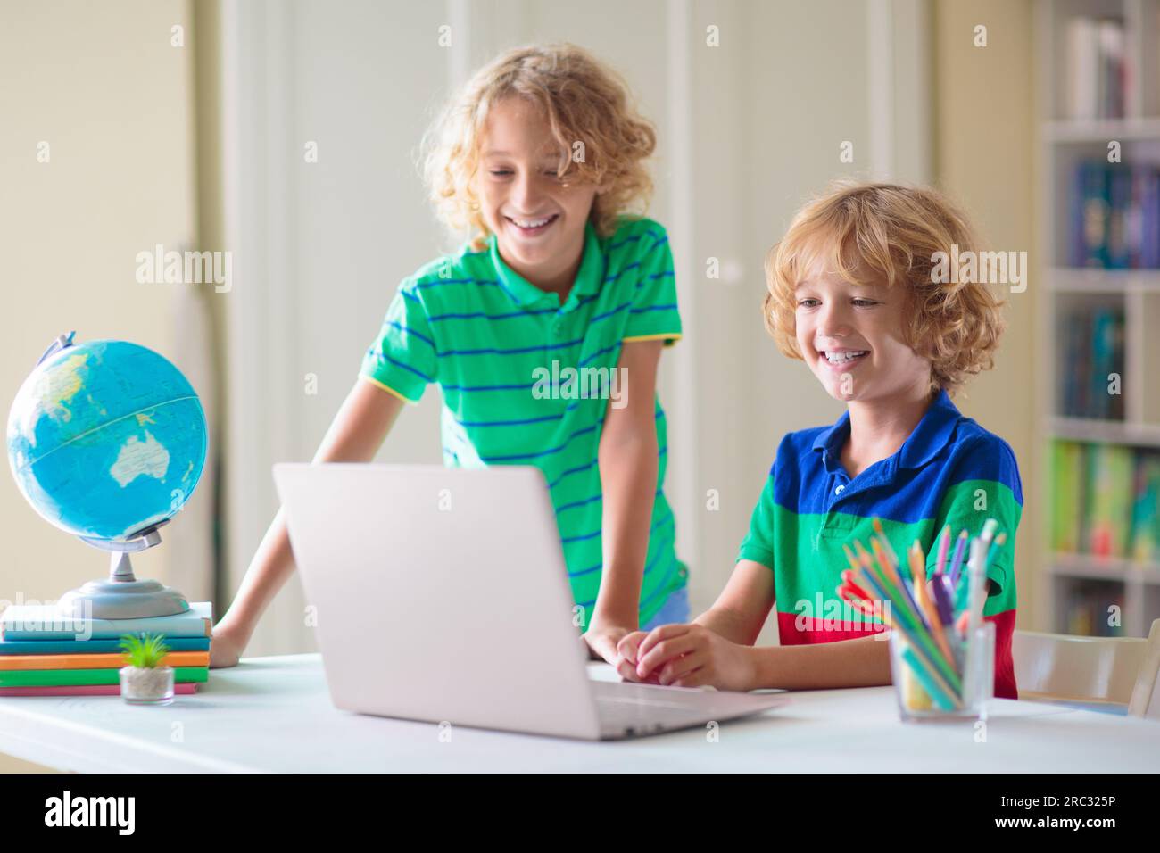 Child doing homework on computer. Online class. Homeschooling and ...