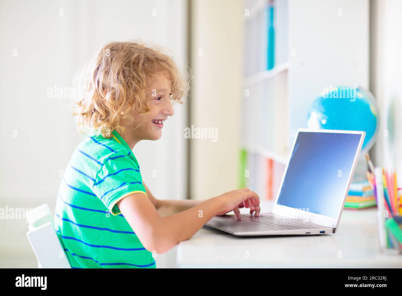 Child doing homework on computer. Online class. Homeschooling and ...