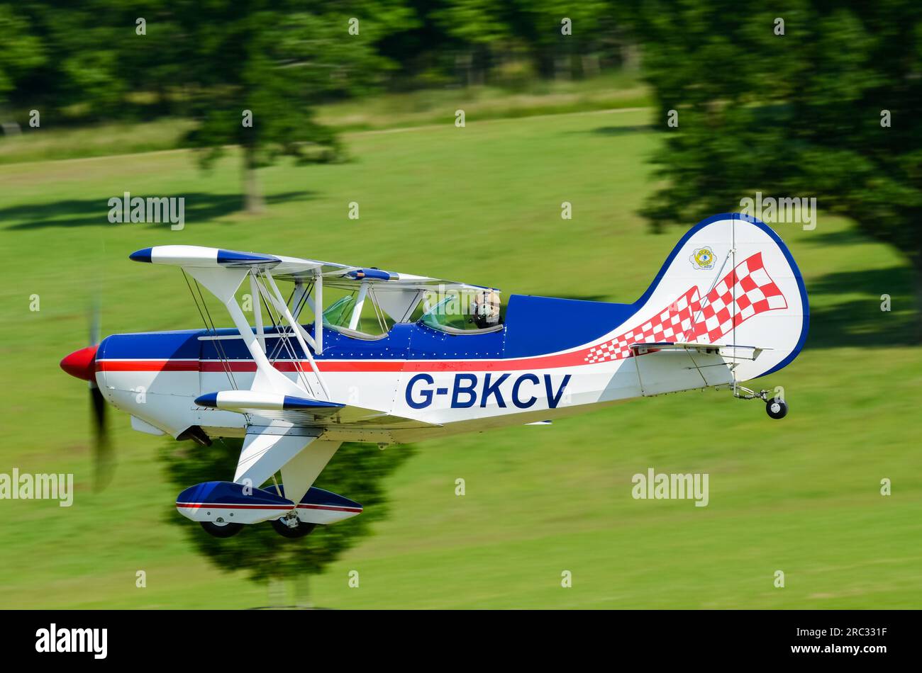 EAA Acro Sport II plane G-BKCV taking off from grass airstrip at a fly ...