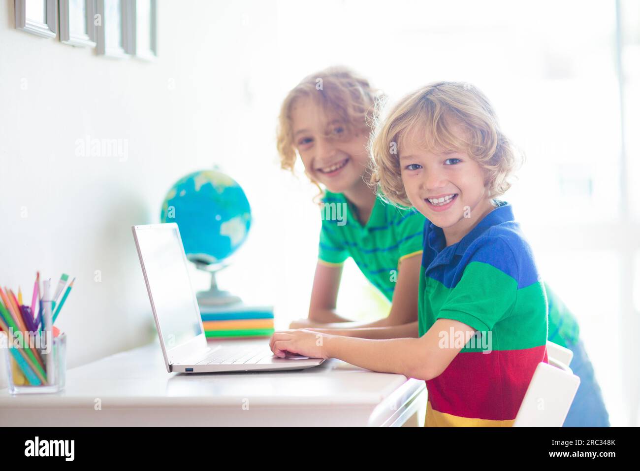 Child doing homework on computer. Online class. Homeschooling and ...