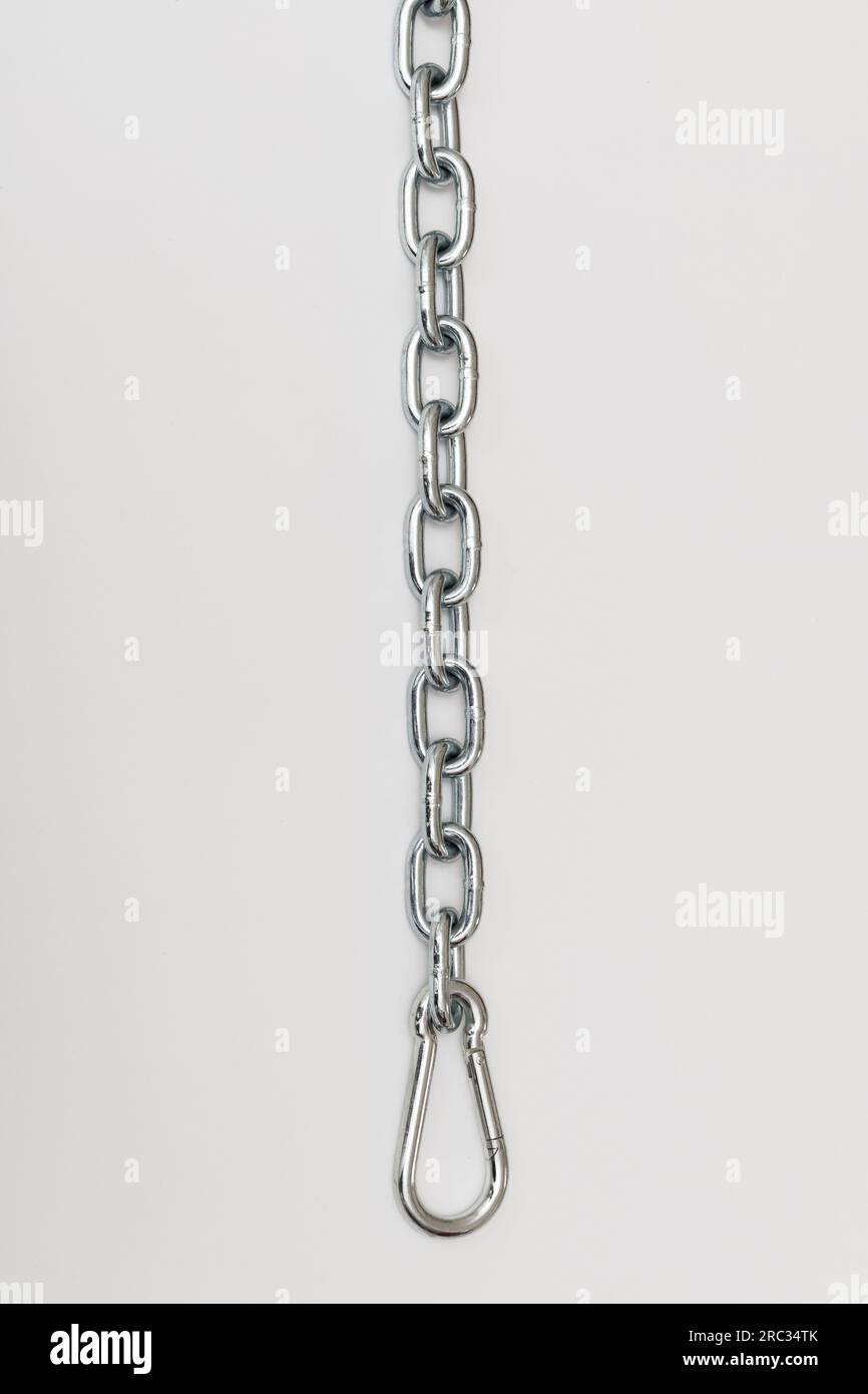 Top view of shiny metallic chain with metal rings and carabiner placed ...