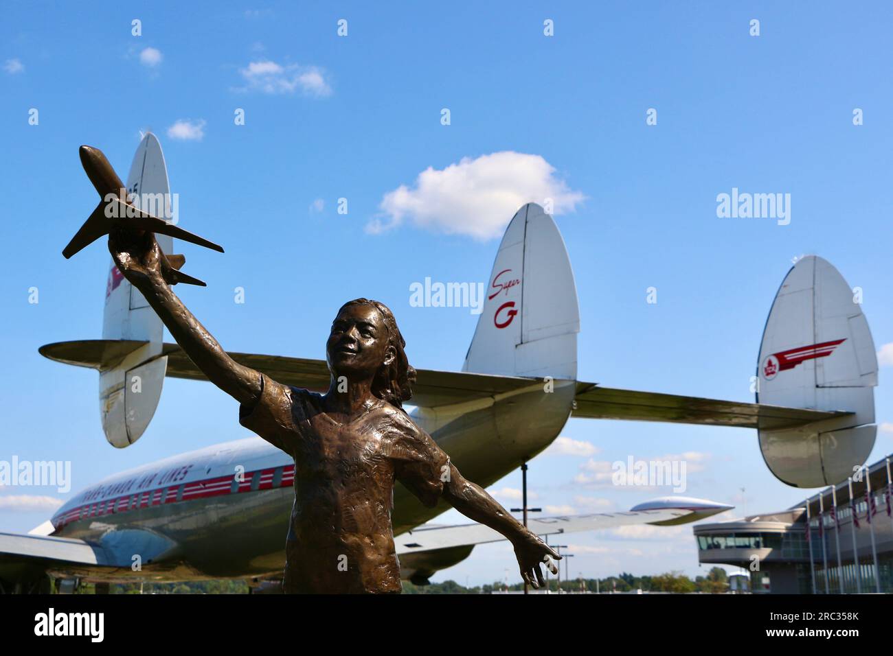 Bronze statue of a child with a Boeing 747 Jumbo Jet standing on the ...