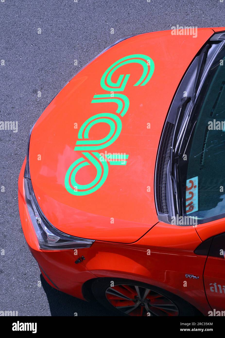 grab text on an orange grab taxi cab in Bangkok, Thailand, Asia Stock ...