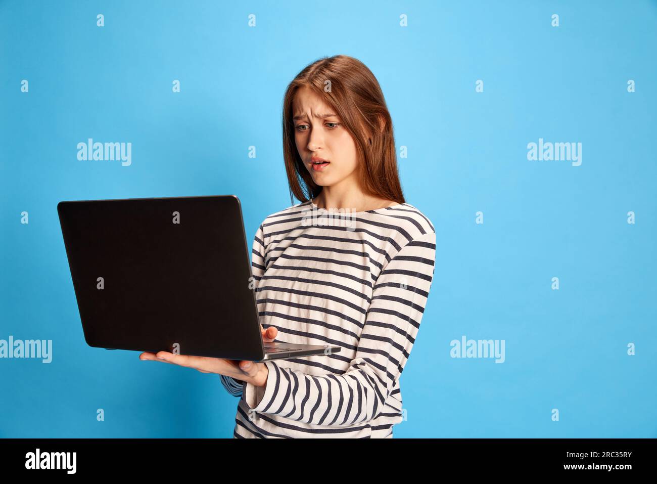Error. Portrait of young girl in casual clothes looking with worried ...