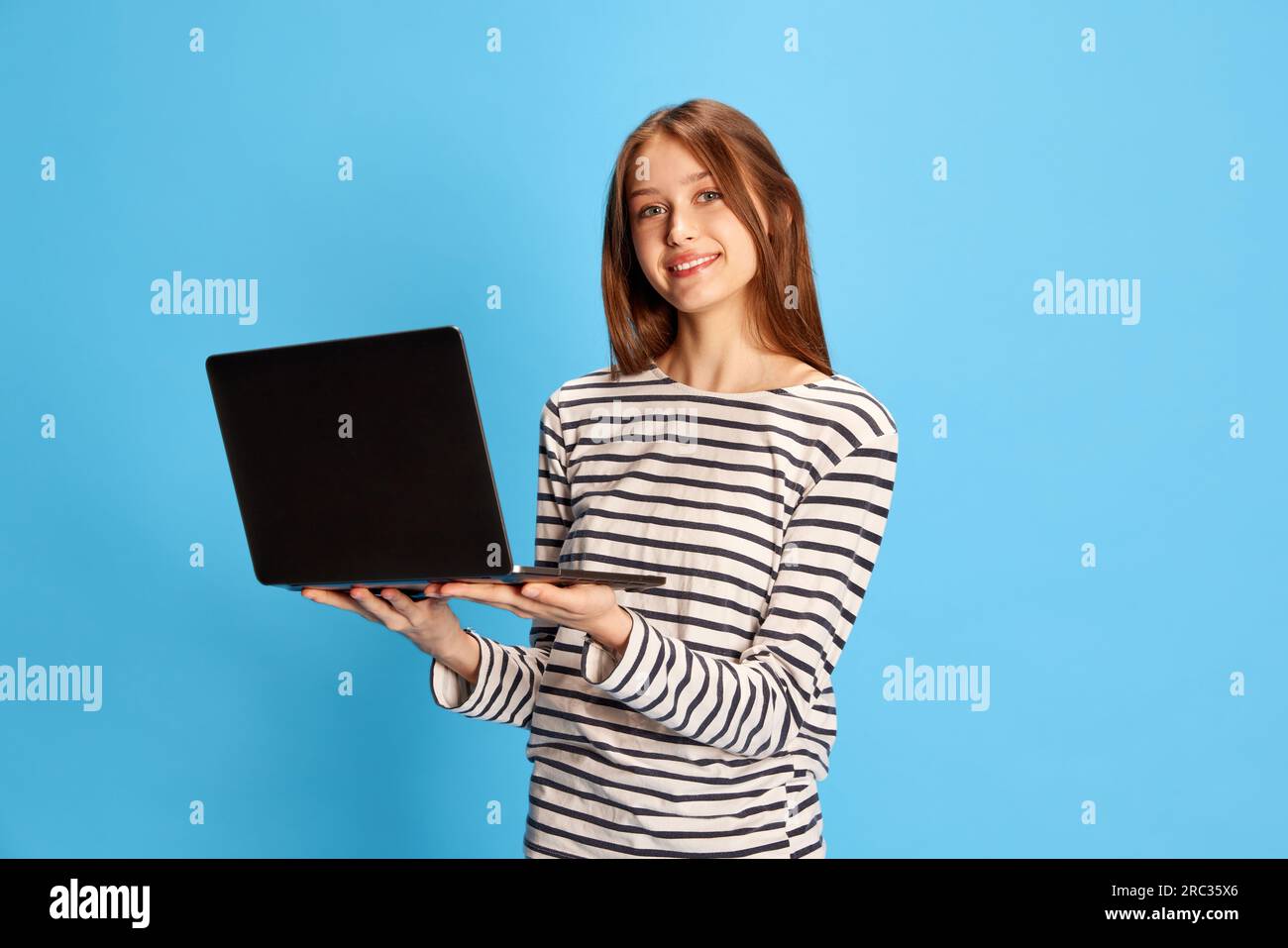 Job fair. Young pretty girl standing with laptop and smiling against ...