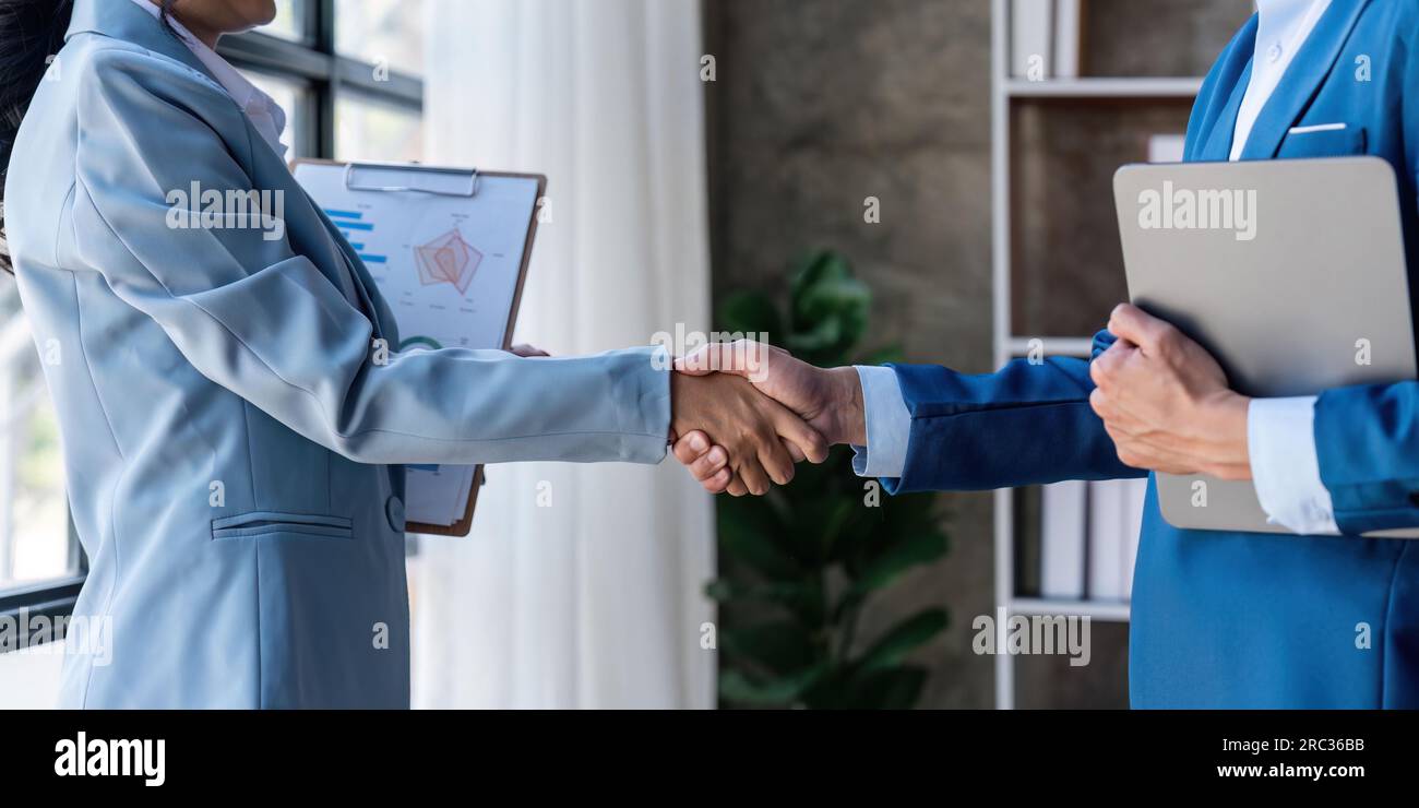 business young woman signing contracts and handshake with a manager man ...