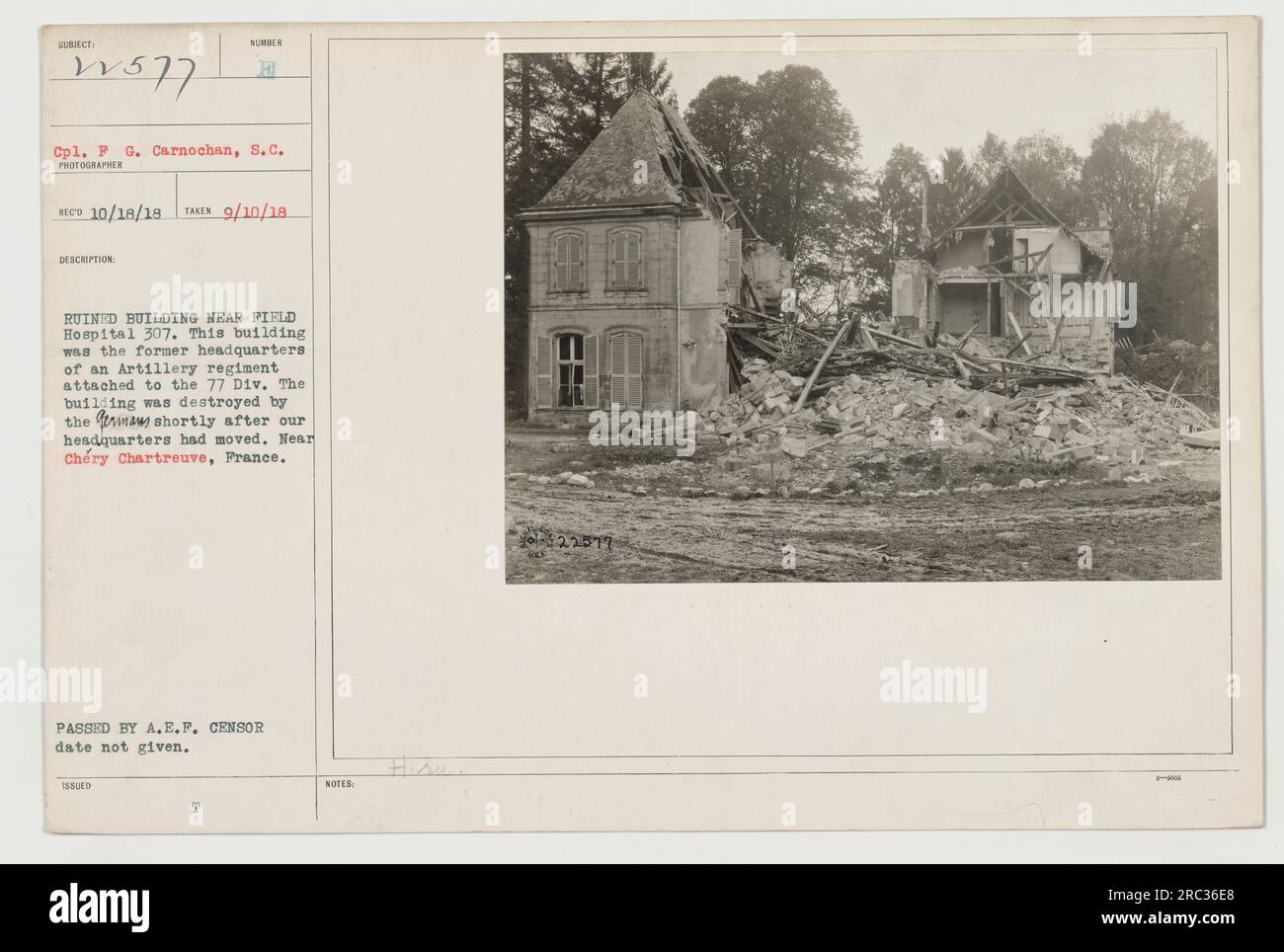 Cpl. P G. Carnochan stands in front of a ruined building near Field ...