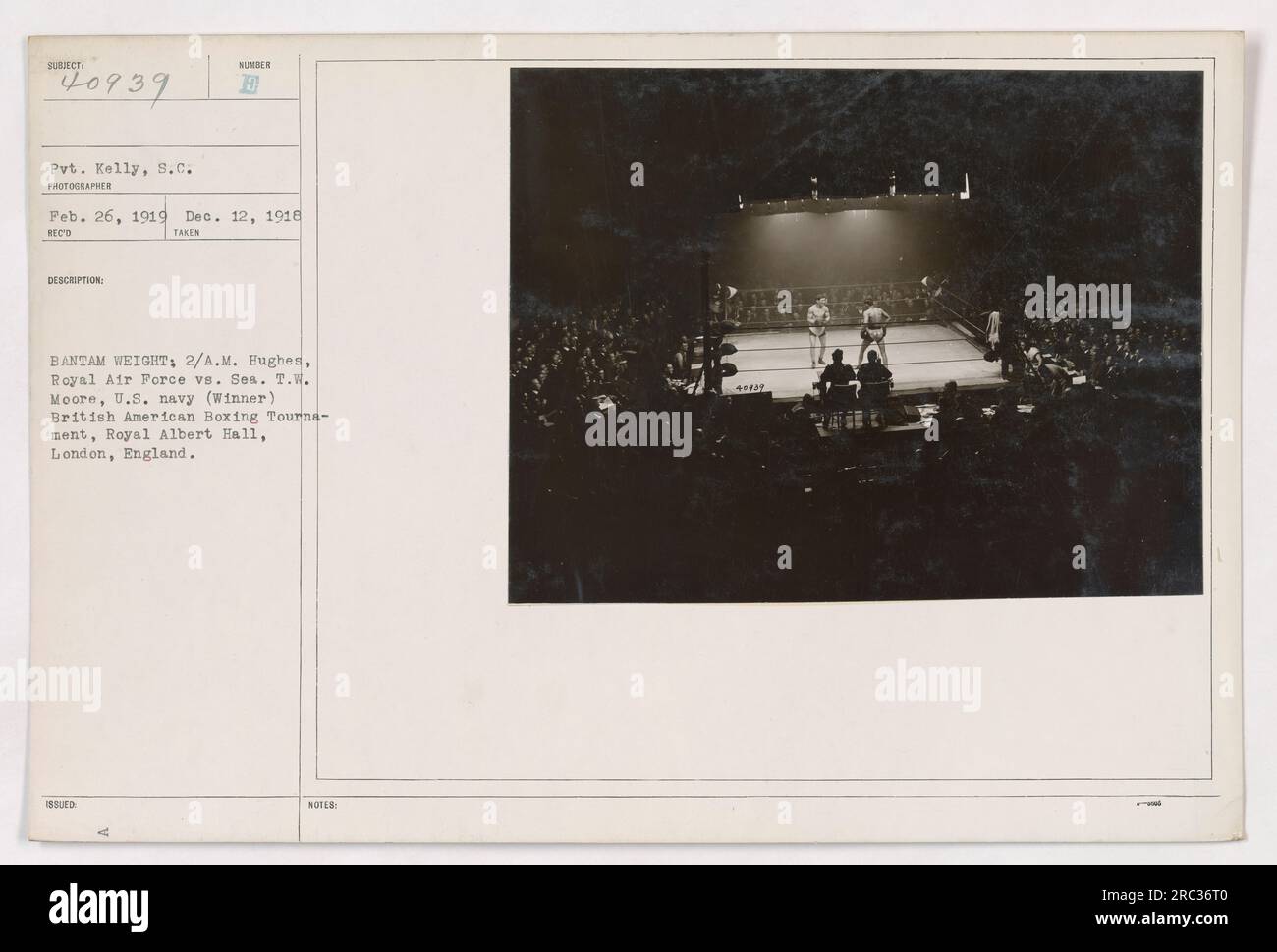 Pvt. Kelly takes a photograph of a boxing match between 2nd Class Air ...