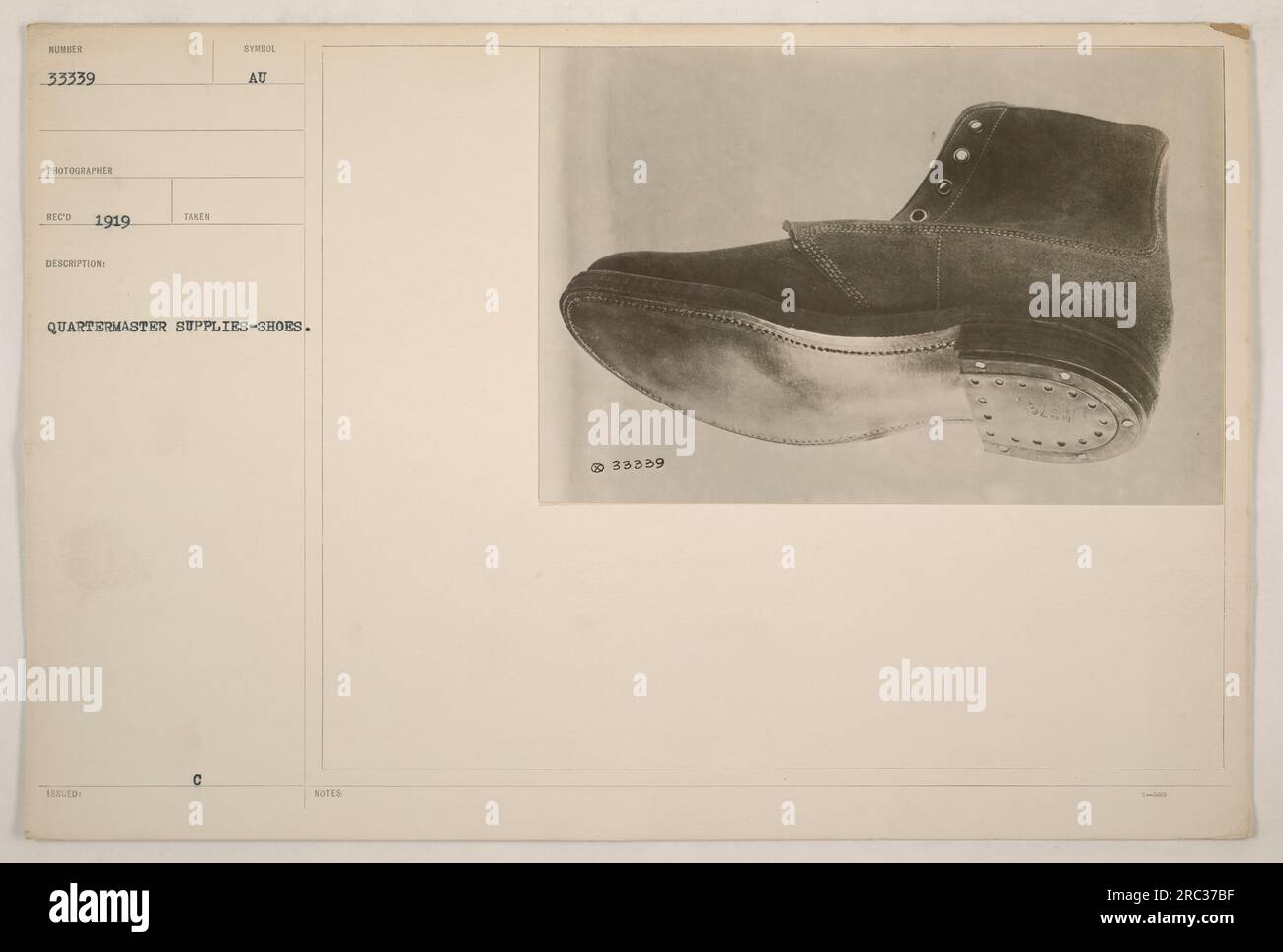 American soldiers at the quartermaster supplies area inspecting shoes ...