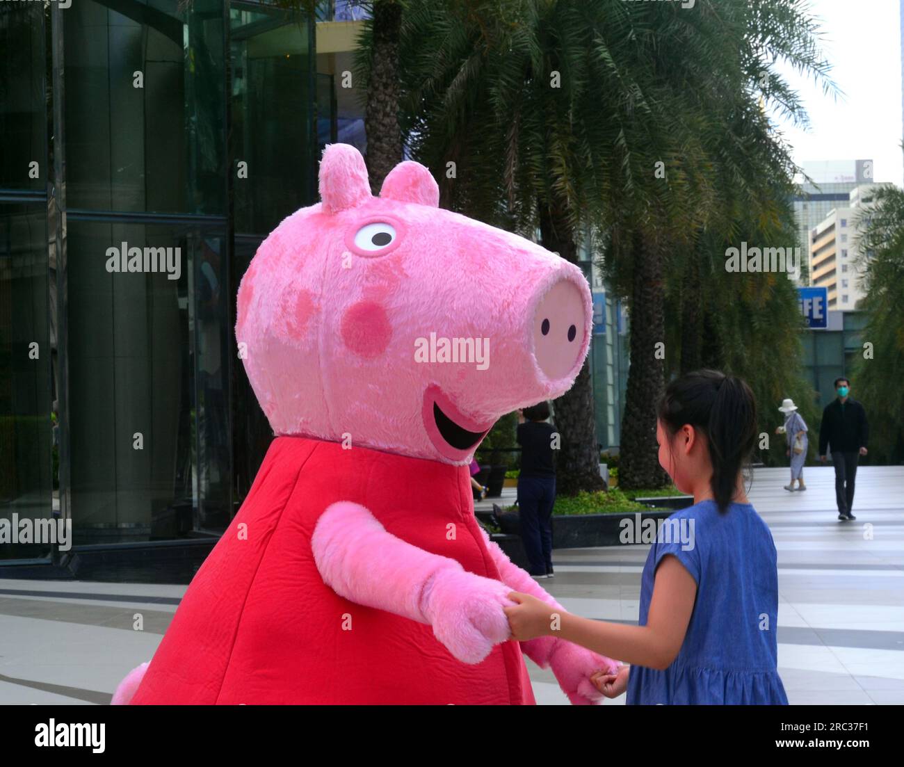 Person dressed in Peppa Pig costume welcomes visitors to Siam Mall, in ...