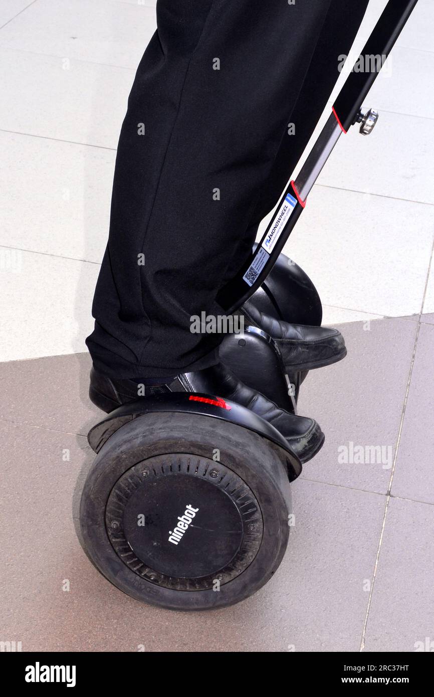 man uses a Segway, a two-wheeled, self-balancing personal transporter ...