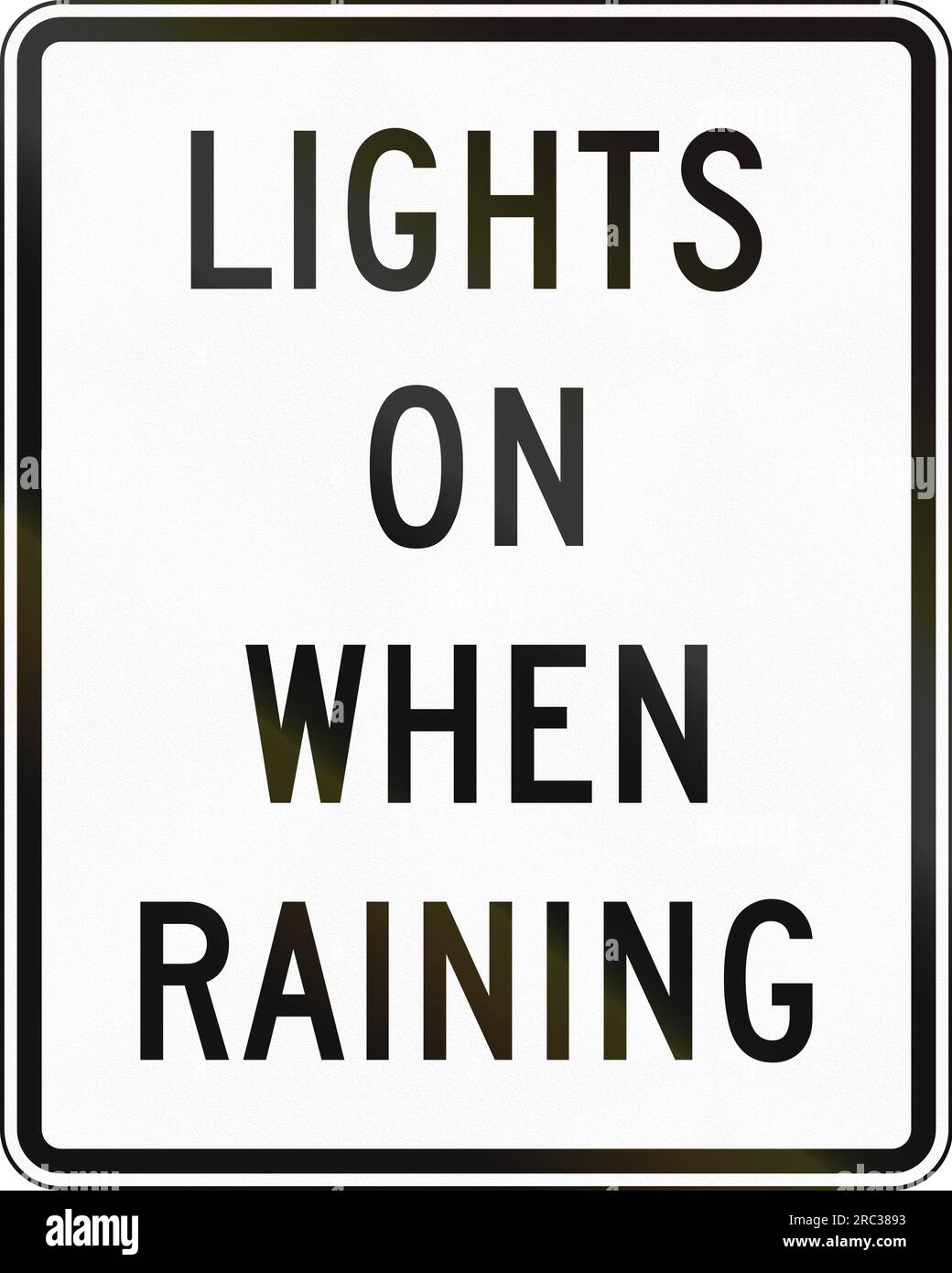 United States traffic sign: Lights on when raining Stock Photo - Alamy