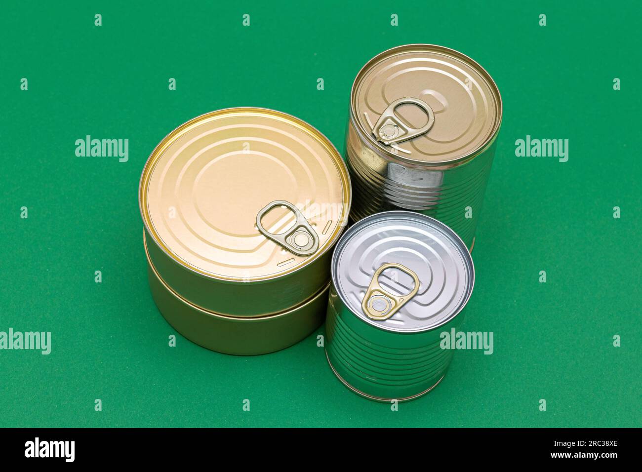 A Group of Stacked Tin Cans with Blank Edges on Green Background ...