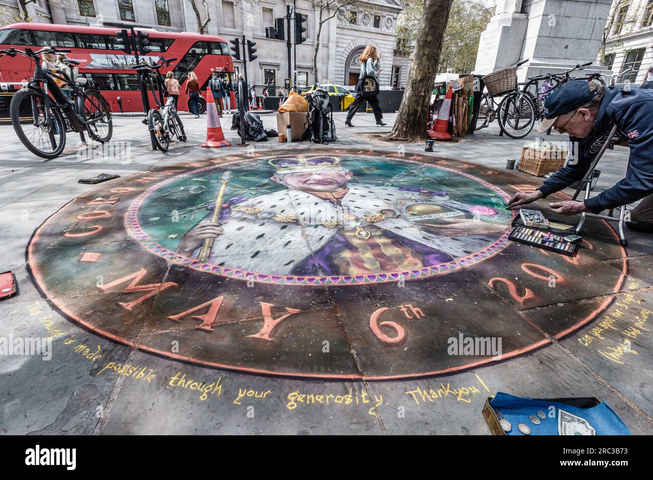 A street artist puts his finishing touches on his coronation pavement ...