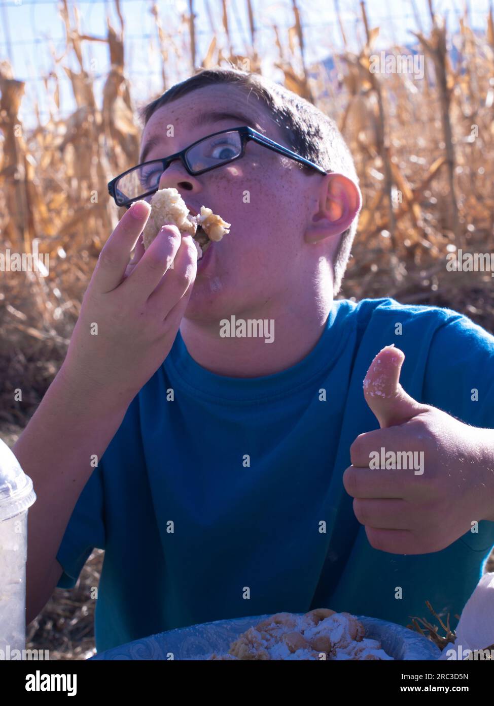 Young Boy Eating Funnel Cake Stock Photo - Alamy