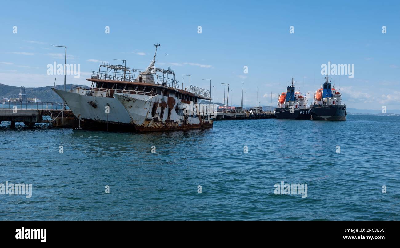 Elefsina Attica Greece. Abandoned burned ship moored at port. Tilted ...
