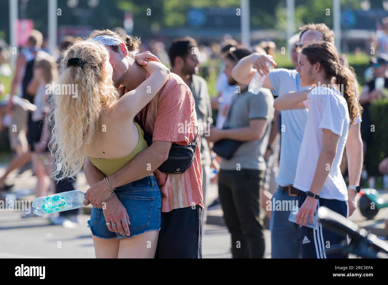 Berlin,Germany,8th July, 2023, A couple passionately embraces and revels in the grandest techno ...