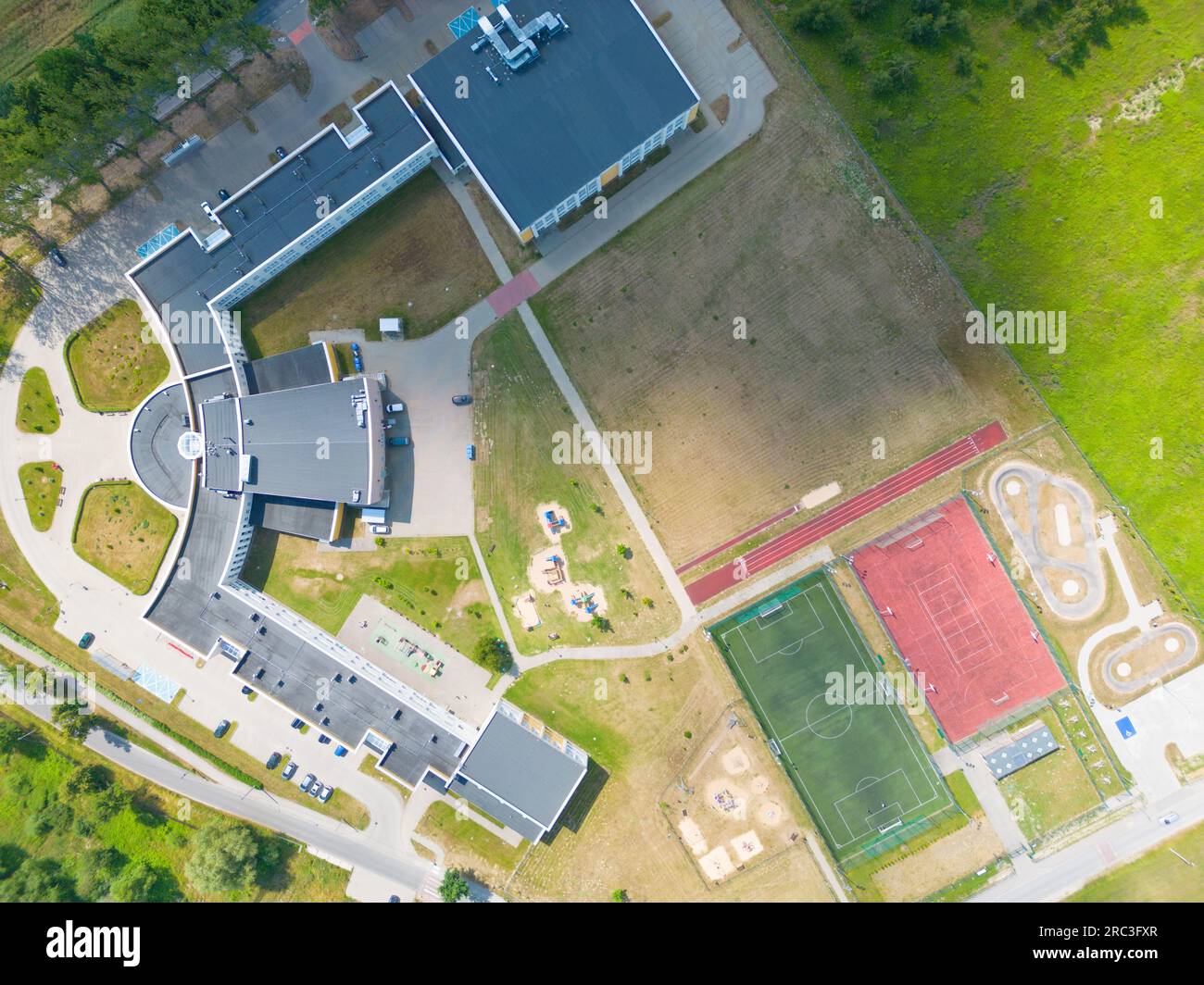 school sports ground with football stadium, jogging tracks around ...