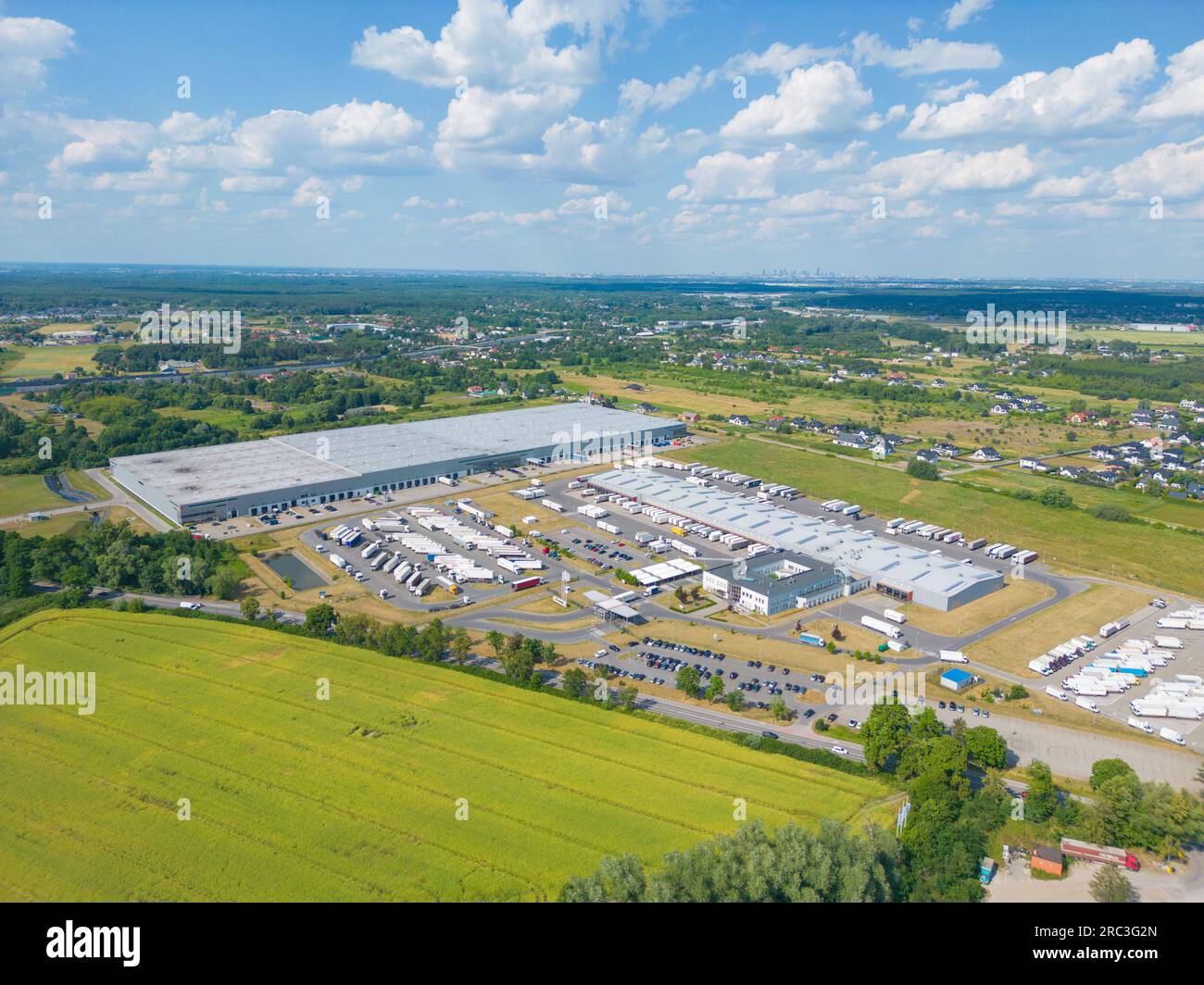 Aerial view of storage and freight terminal with trucks and containers ...