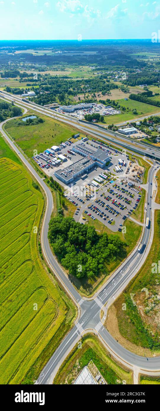 Aerial view of storage and freight terminal with trucks and containers ...
