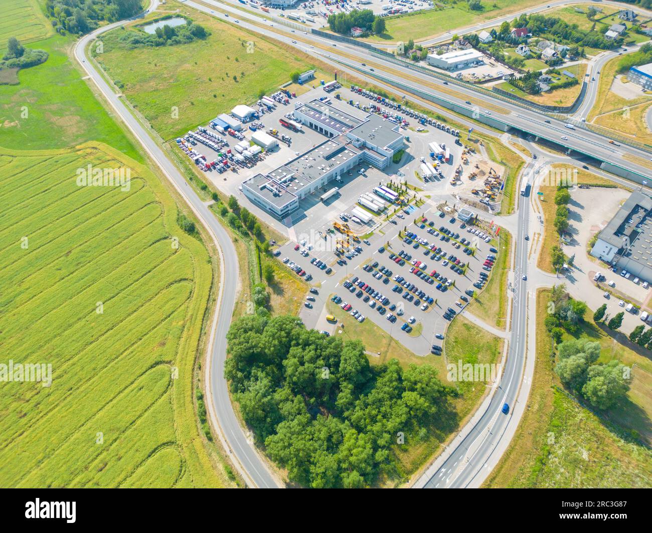Aerial view of storage and freight terminal with trucks and containers ...