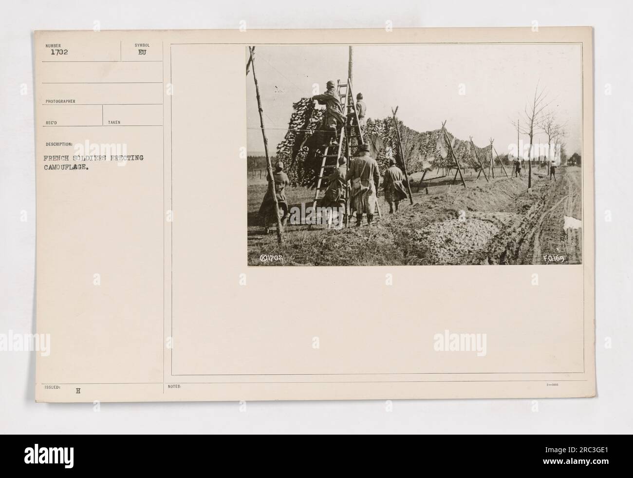 French soldiers erecting camouflage for their military activities ...