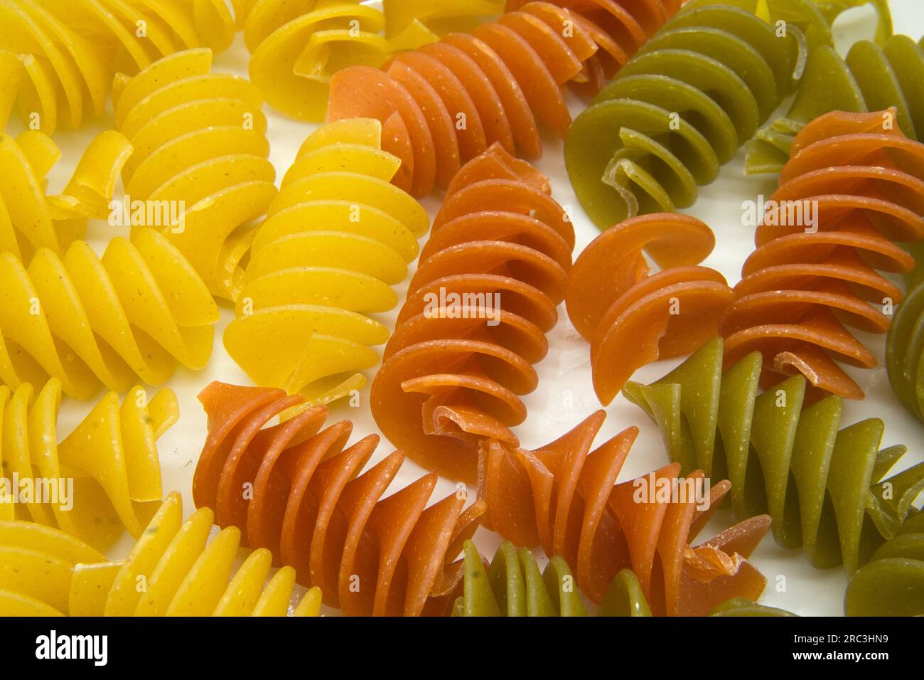 Close up or Tri-coloured Large Spiral Pasta on a white background Stock ...