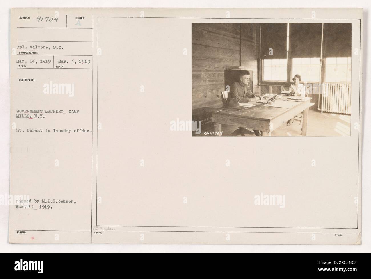 Caption: Cpl. Gilmore photographs Lt. Durant in the laundry office at ...