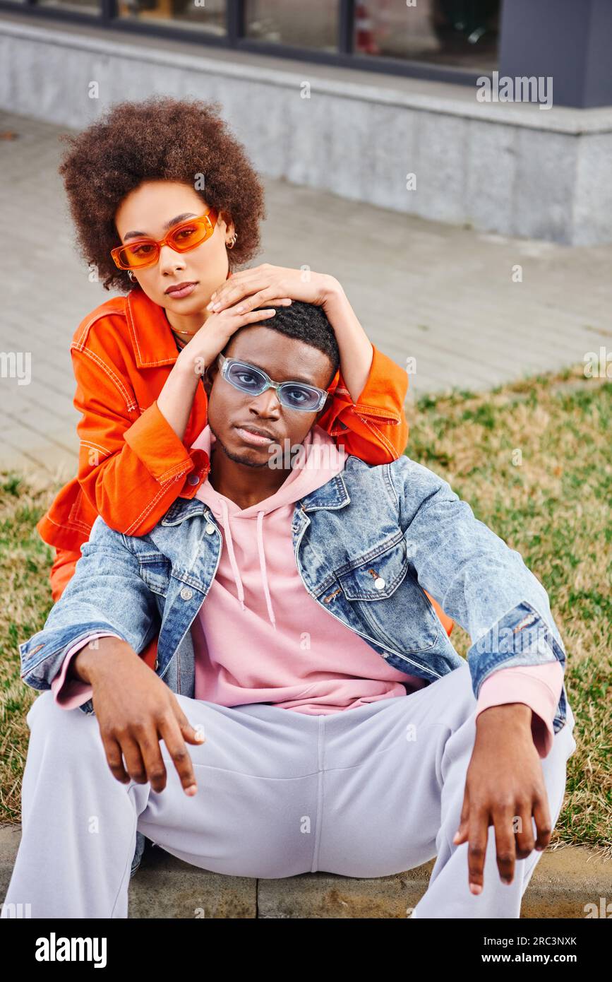 Trendy young african american woman in sunglasses and bright outfit ...